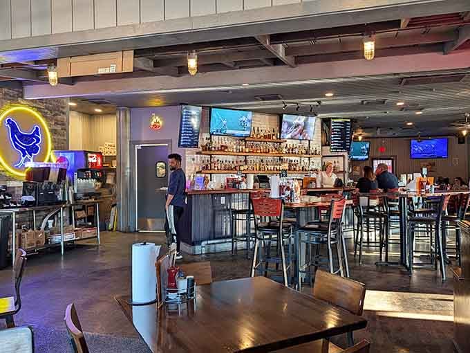 Industrial chic meets comfort food heaven, where exposed beams and neon chickens create the perfect casual dining atmosphere.