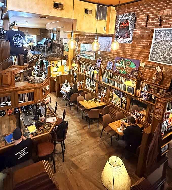 Books, exposed brick, and golden lighting create the kind of atmosphere that makes you want to move in permanently.
