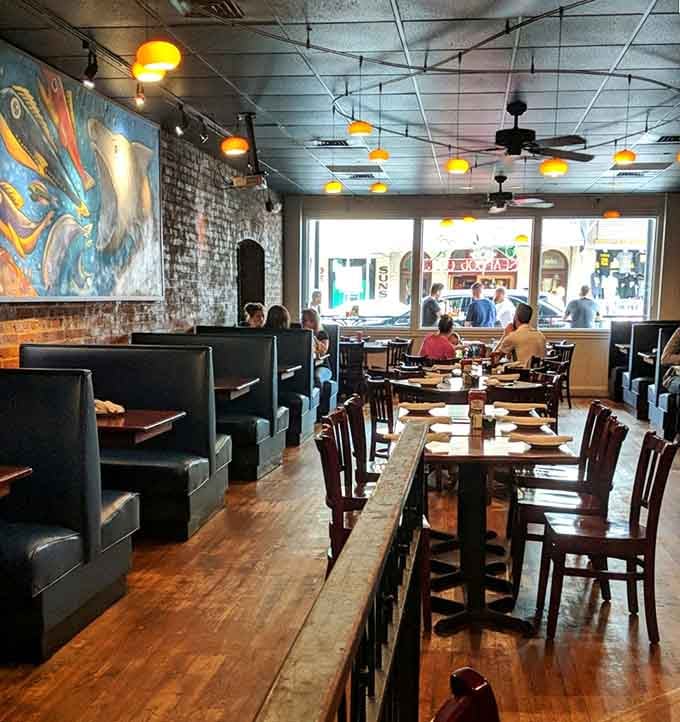 Exposed brick meets ocean-inspired art in a space that proves landlocked cities can nail the coastal vibe.