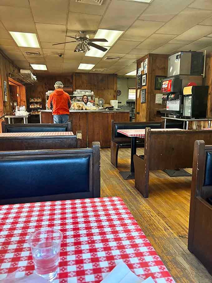 Wood paneling and checkered tablecloths: the official uniform of places that take their sandwiches seriously.