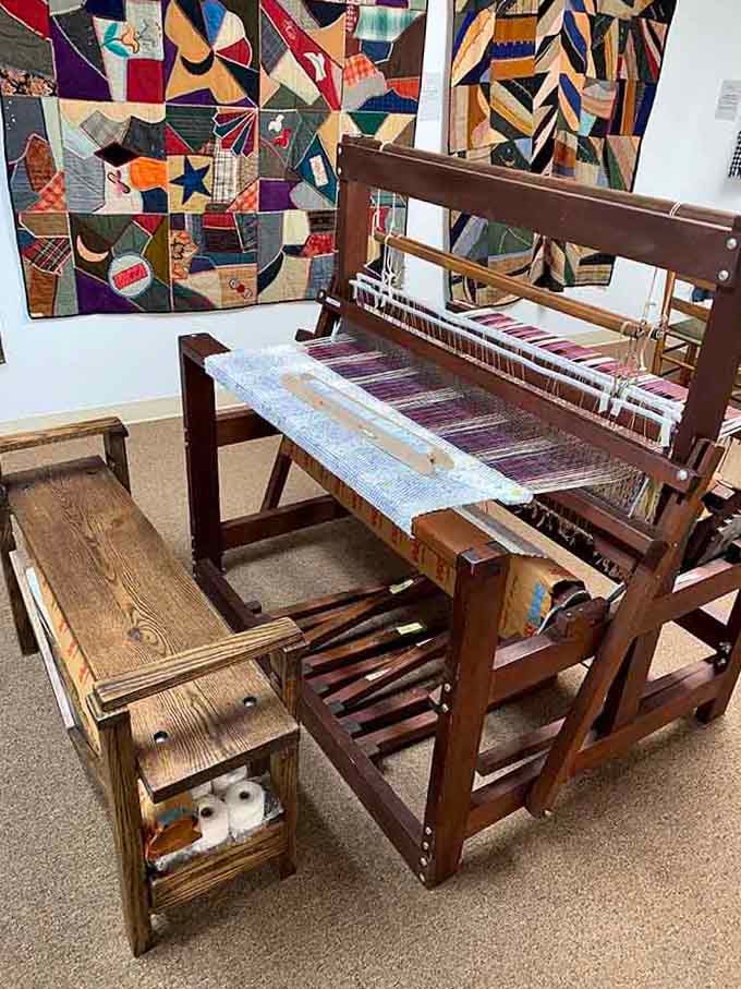 That wooden loom looks like it could weave stories as easily as it weaves textiles and threads.