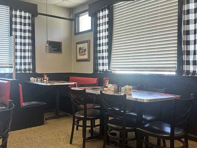 Black and white checkered curtains frame booths where generations have solved the world's problems over coffee.