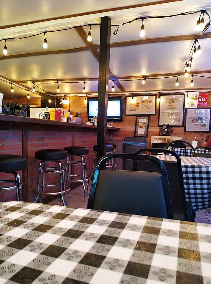 String lights and checkered tables create the kind of cozy atmosphere that makes every meal feel special.