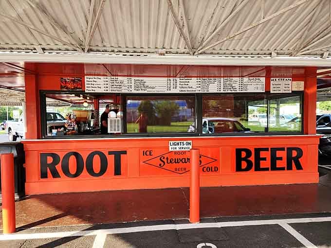 Bold orange signage advertising root beer and cold beer proves that sometimes the best marketing is just telling the truth.