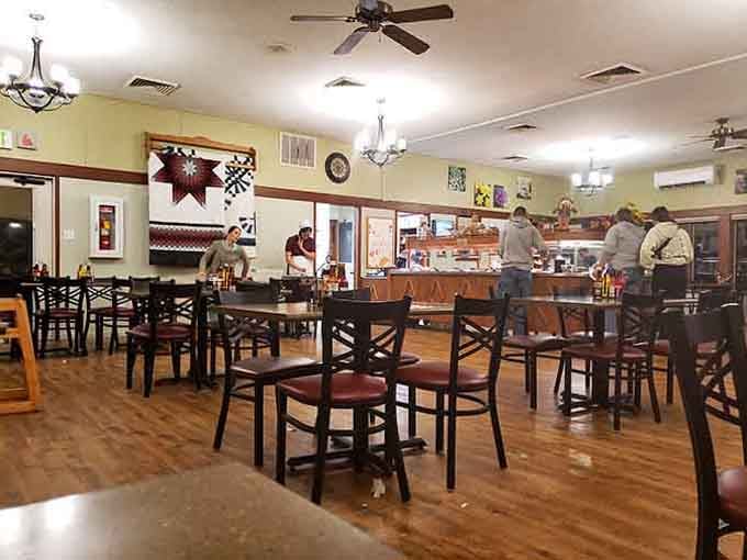 Warm lighting and wooden tables create the kind of welcoming atmosphere where strangers become friends over shared pie recommendations.