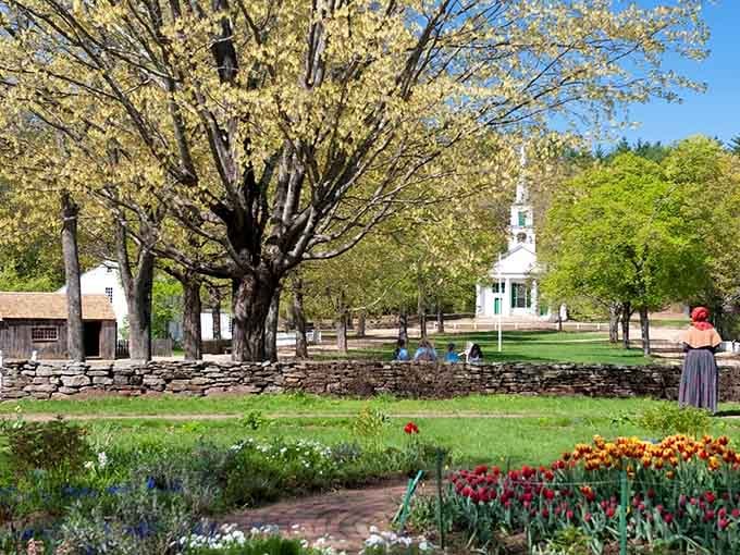 Spring blooms frame the village common where costumed interpreters make 1830s life look surprisingly appealing.