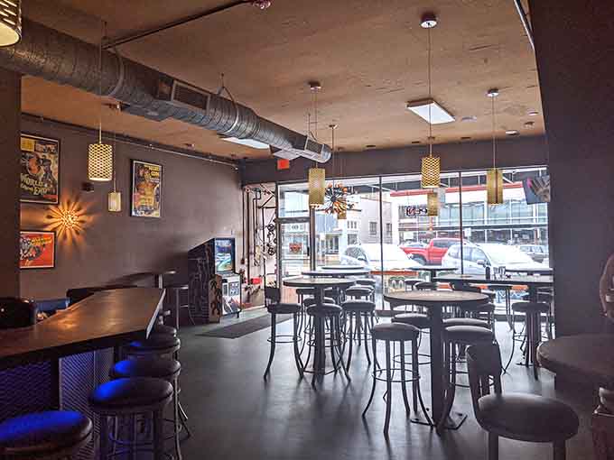 Large windows flood the space with natural light, proving arcade bars don't have to feel like underground bunkers.