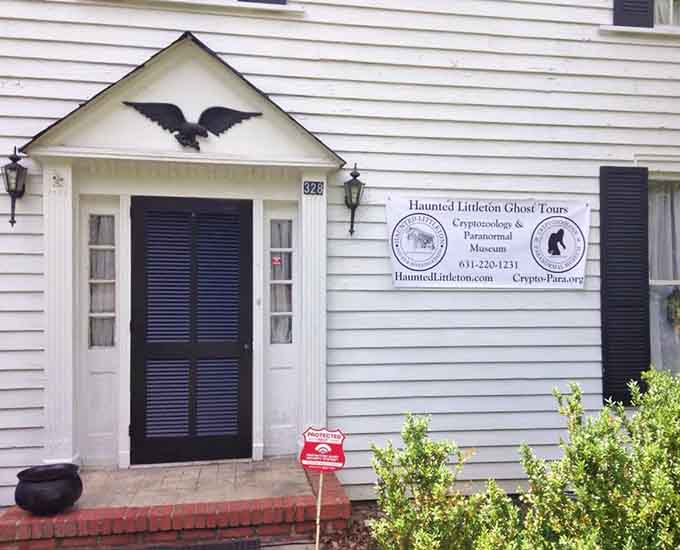 That raven perched above the entrance knows something you don't, and the ghost tour sign suggests you're about to find out.