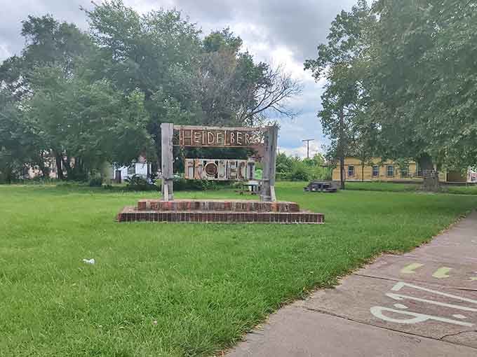 The handcrafted sign welcomes you to an outdoor gallery where everyday objects become profound artistic statements.