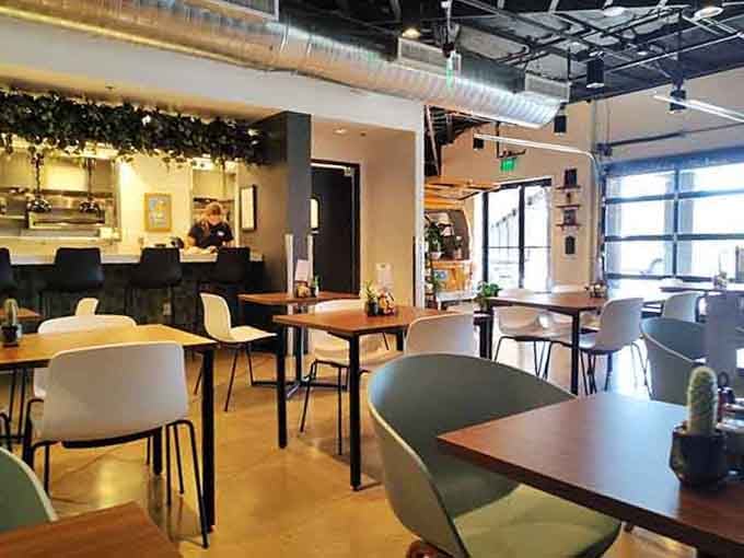 Modern meets cozy in a space where exposed ceilings and greenery create the perfect backdrop for meaningful meals.