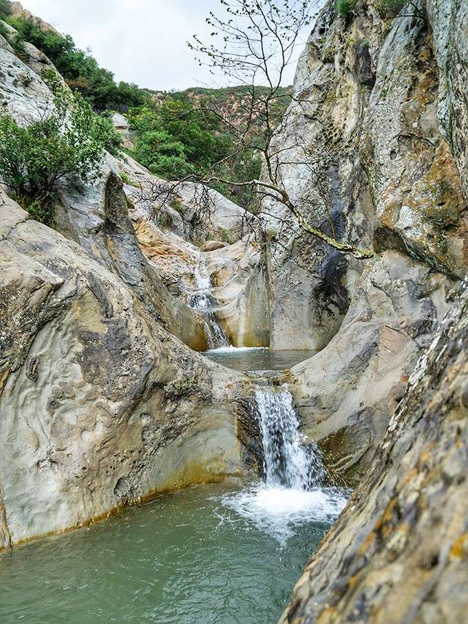 Each cascade tumbles into the next like a perfectly choreographed water ballet, except Mother Nature never needs rehearsal.