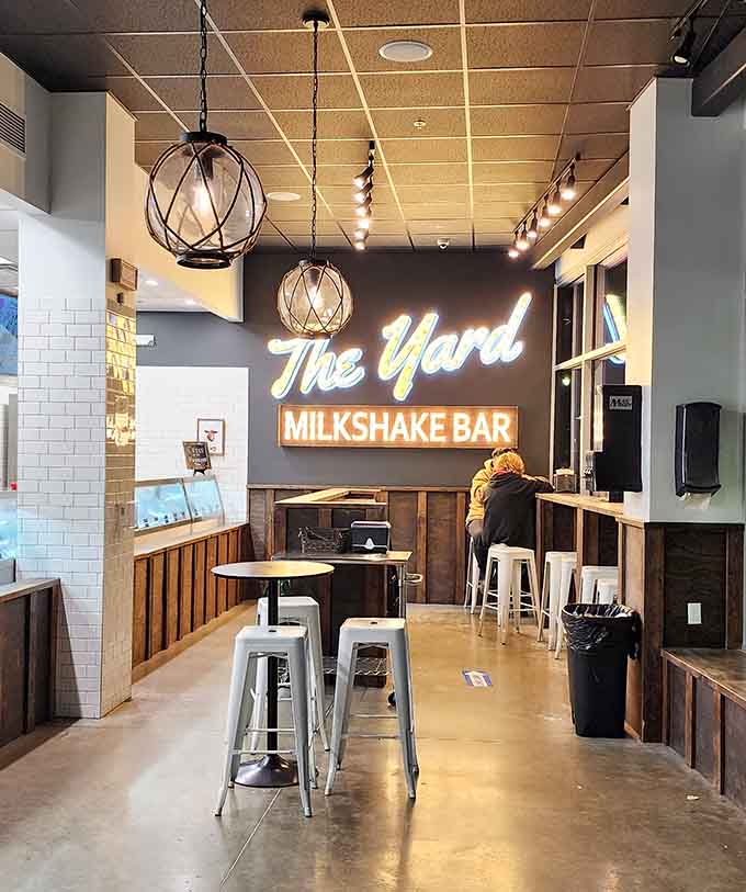 Warm wood, glowing neon, and metal barstools set the stage for serious milkshake business at The Yard.