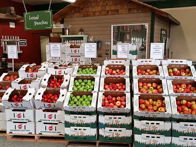 Boxes of crisp apples and juicy peaches stacked like edible architecture, ready to transform your road trip snacks.