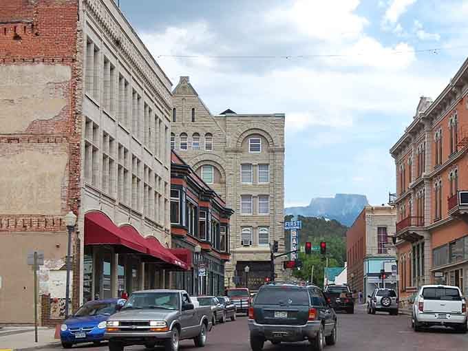 Victorian brick buildings frame mountain views that make your morning commute look like a screensaver.