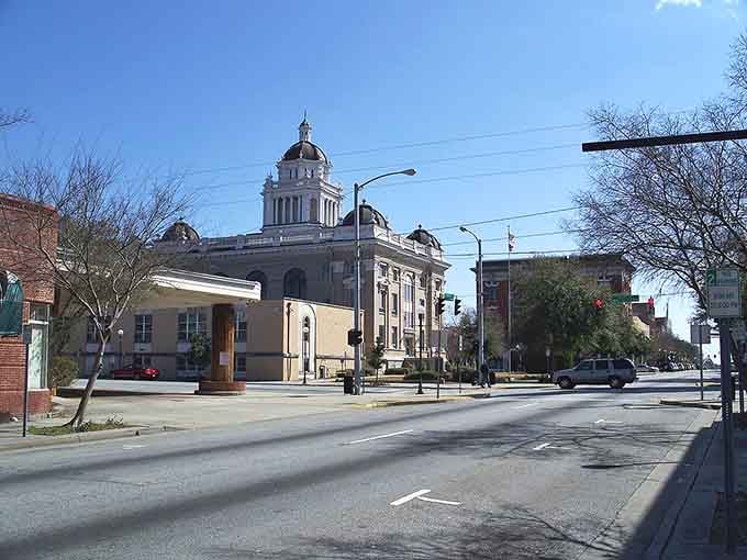 The courthouse stands proud like a Southern belle at her debutante ball, anchoring downtown's timeless appeal.