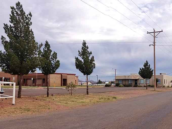 Wide streets and wider skies define this desert town where power lines connect civilization across endless horizons.