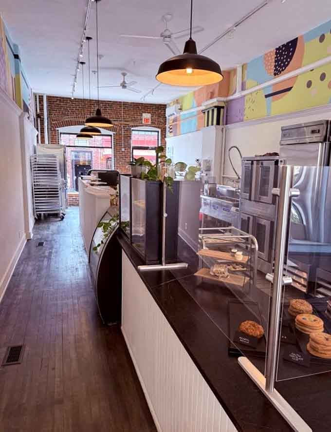 Exposed brick walls meet colorful murals in this inviting bakery space where handcrafted treats line the display case waiting to make your day better.