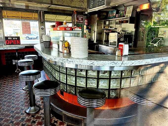 The horseshoe counter where strangers become friends and everyone leaves happy, full, and slightly greasy.