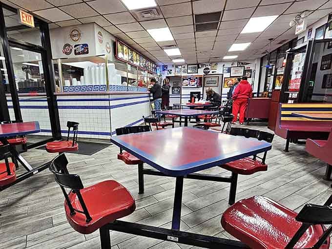 Classic red tables trimmed with blue signal serious comfort food ahead, no fancy reservations or dress codes required here.