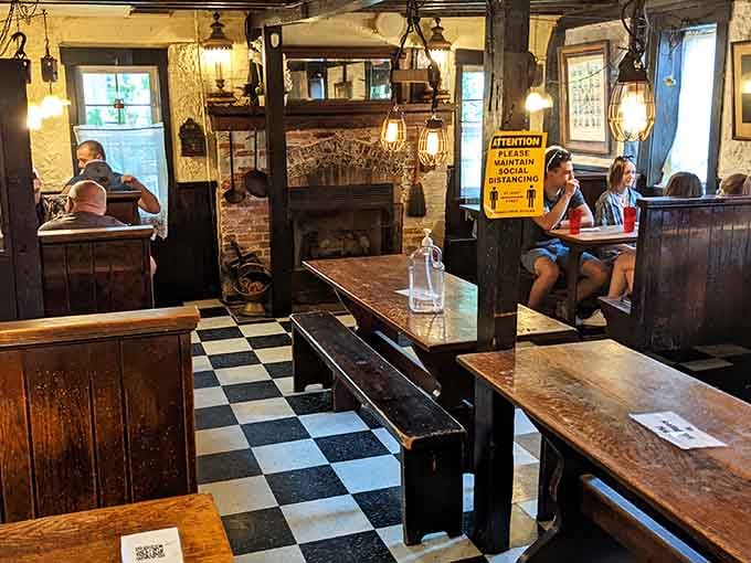 Step inside and find yourself in a time capsule where checkered floors meet rustic beams and history feels deliciously alive.