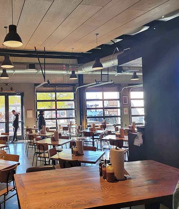 Industrial-chic meets Texas comfort in this airy space where exposed ductwork and wooden tables set the stage.