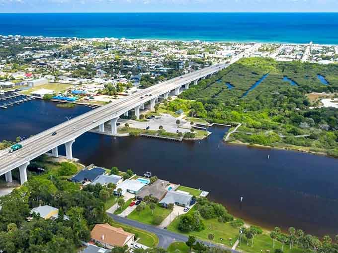 The elevated highway stretches across dark lagoon waters, connecting coastal communities with engineering grace and stunning views.