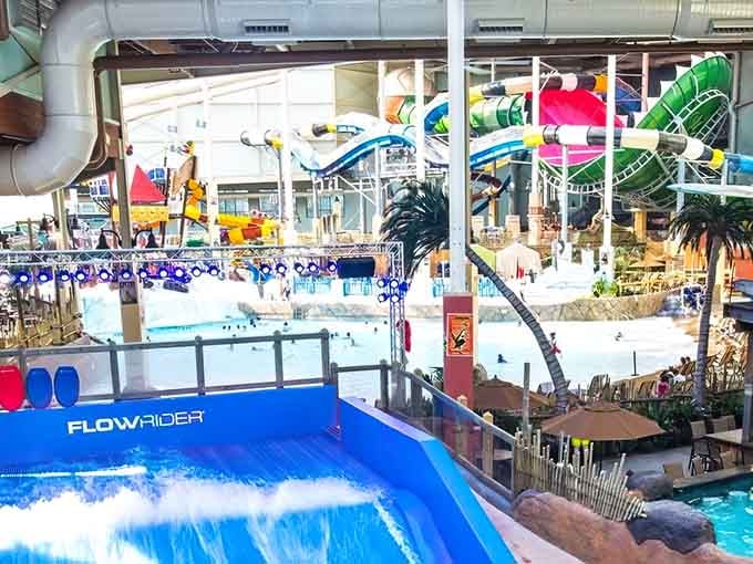 The FlowRider beckons brave souls to test their surfing skills while palm trees watch overhead indoors.