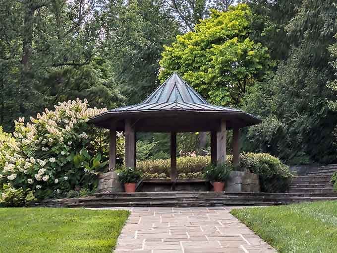This elegant gazebo sits like a crown jewel among manicured lawns and flowering shrubs in peaceful harmony.