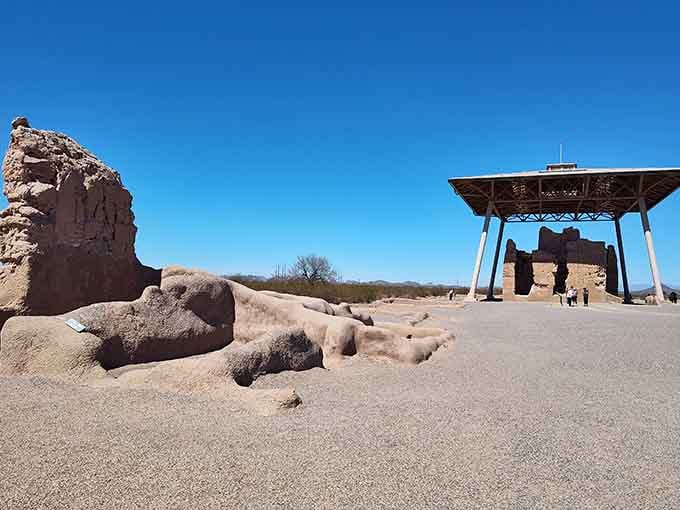The modern shelter protects these 700-year-old mud walls that have witnessed centuries of desert sunrises and storms.
