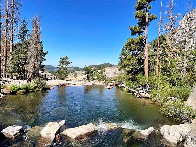 Mountain-fed pools shimmer under Sierra skies, where granite meets crystal-clear water in perfect harmony every single time.
