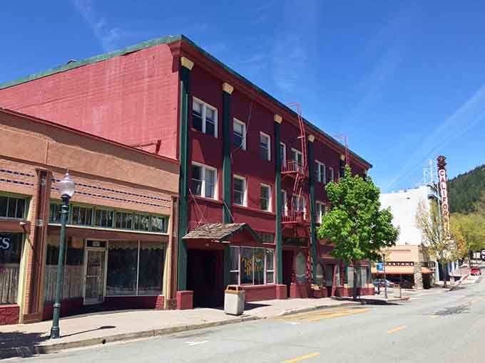 That crimson building pops against the mountain backdrop like a vintage postcard you'd actually want to send home.