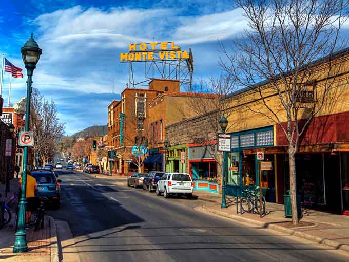That iconic Hotel Monte Vista sign glows like a beacon, welcoming travelers to downtown's historic brick-lined charm.