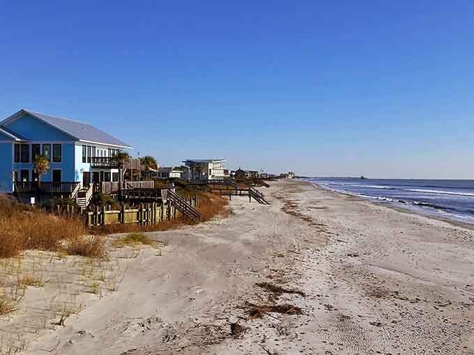 Beach houses perched on stilts watch over this quiet stretch where the ocean whispers instead of roars.