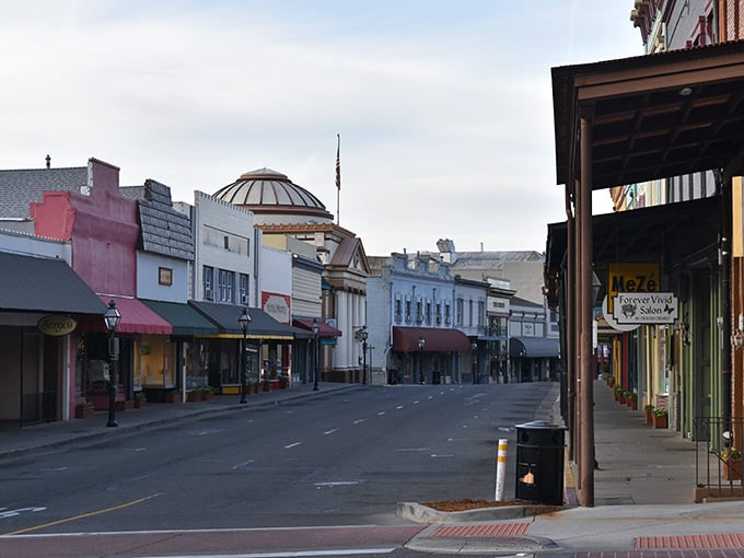 Historic storefronts line this peaceful street where the dome architecture adds unexpected elegance to small-town charm.