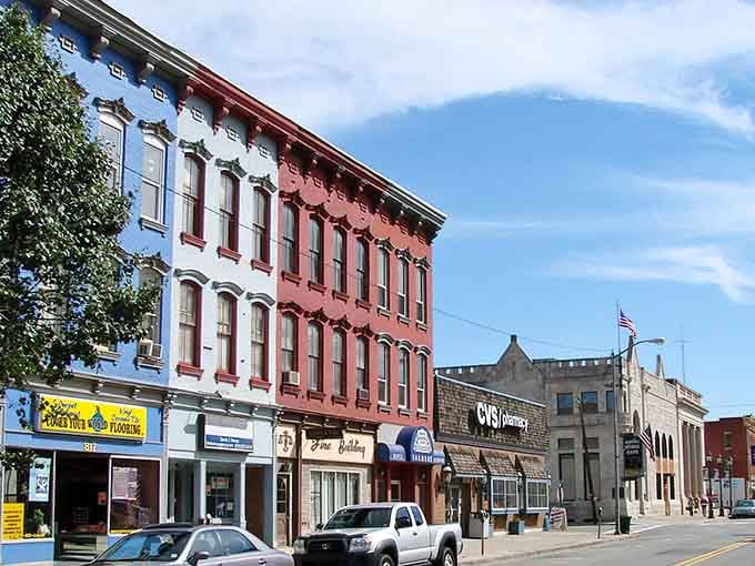 Classic brick buildings in cheerful colors stand shoulder to shoulder, creating the kind of Main Street America used to build everywhere.