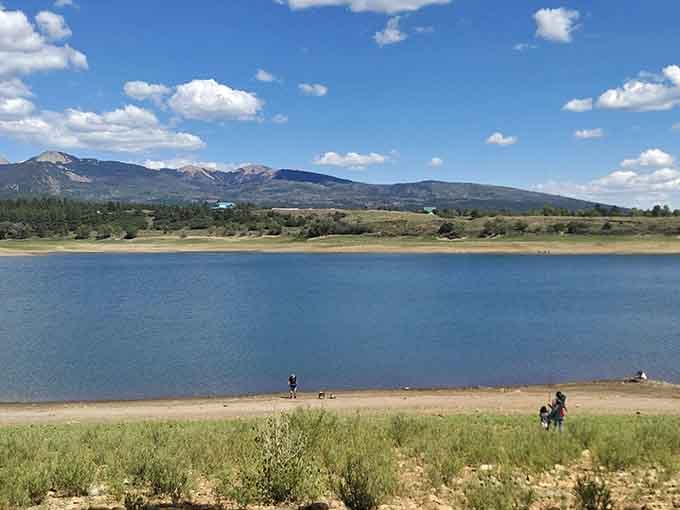 Mountain views framing a peaceful reservoir where families gather to fish and make memories that last forever.