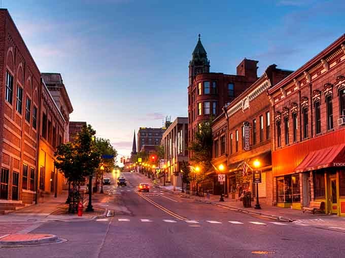 Golden hour bathes Marquette's historic downtown in warm light, making those red brick buildings glow like they're showing off.
