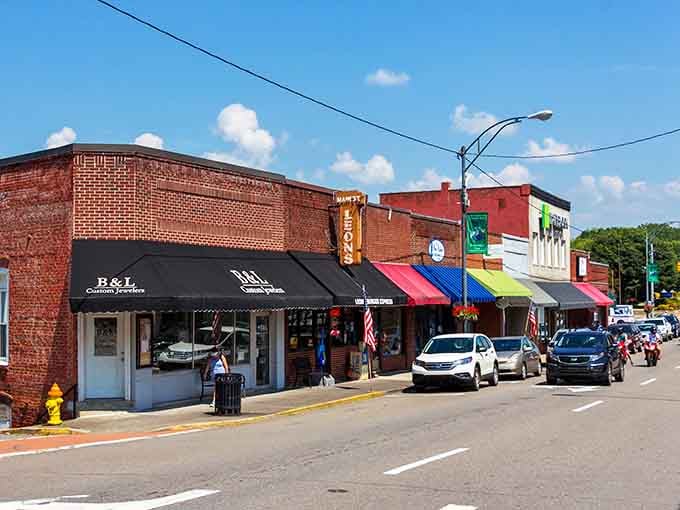 Colorful awnings line these brick buildings like a parade of local pride, each shop telling its own story.