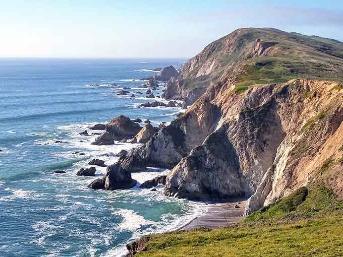 Dramatic cliffs meet crashing waves in a scene so stunning it could make a postcard jealous.