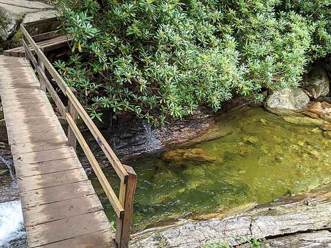 A wooden footbridge leads to crystal-clear mountain water that's been waiting patiently for your summer visit.