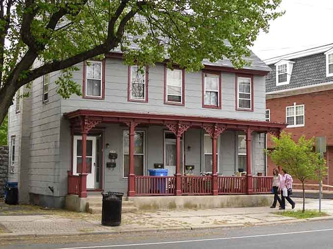 That decorative porch trim says someone built this home with pride and maybe a little showing off.