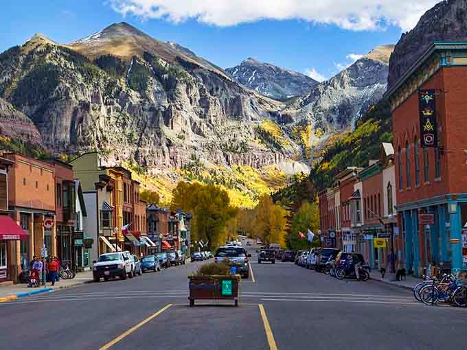 Golden aspens frame Telluride's historic main drag where every view looks like someone's desktop screensaver come to life.