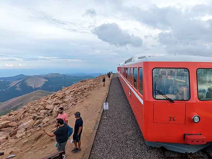 That bright red cog railway climbing toward the clouds carries you higher than most commercial airplanes dare to fly.