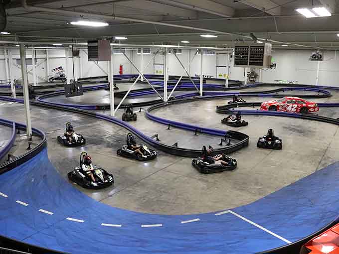Blue barriers snake through this indoor paradise like a racetrack designed by someone who actually understands what fun means.