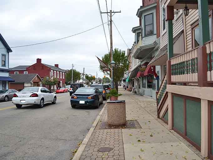 Victorian bay windows and brick sidewalks create a streetscape that belongs on a vintage postcard collection.