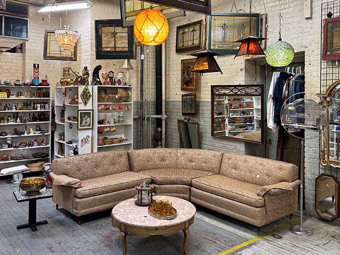 That curved sectional couch looks ready for your living room, surrounded by colorful vintage lamps overhead.