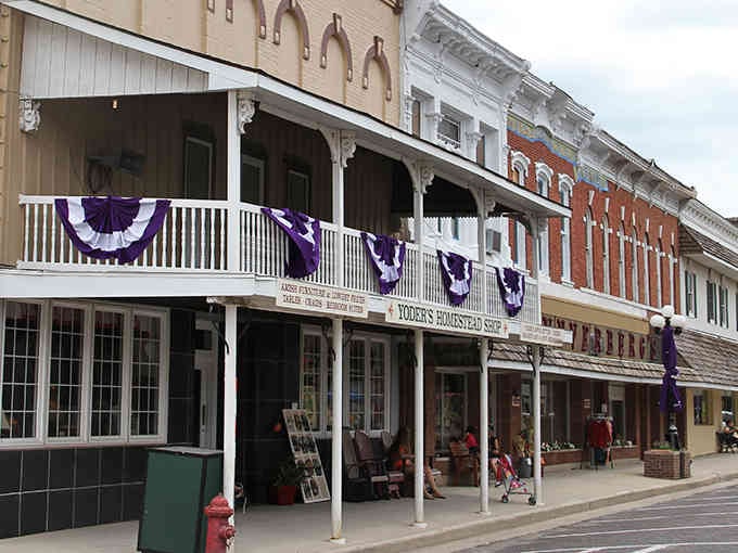 Purple bunting decorates these historic storefronts like a small-town parade that never quite ended, and honestly, why should it?