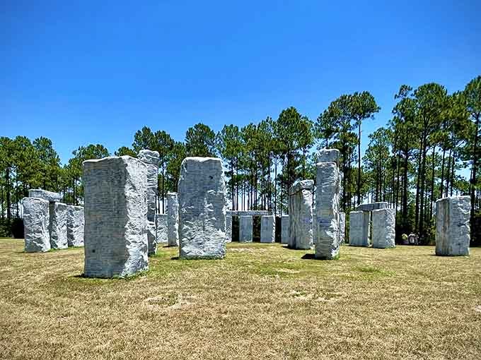 The weathered white stones create perfect shadows across the green grass, inviting you to walk among them like a time traveler.