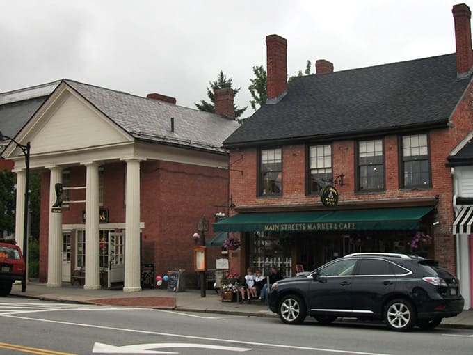 Historic brick buildings house local cafes where conversations flow as freely as the coffee on lazy afternoons.