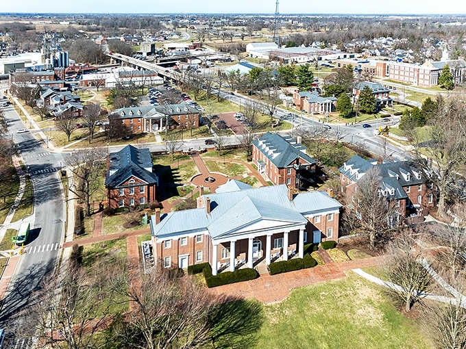 From above, historic buildings nestle together like old friends sharing stories across the generations beneath open skies.